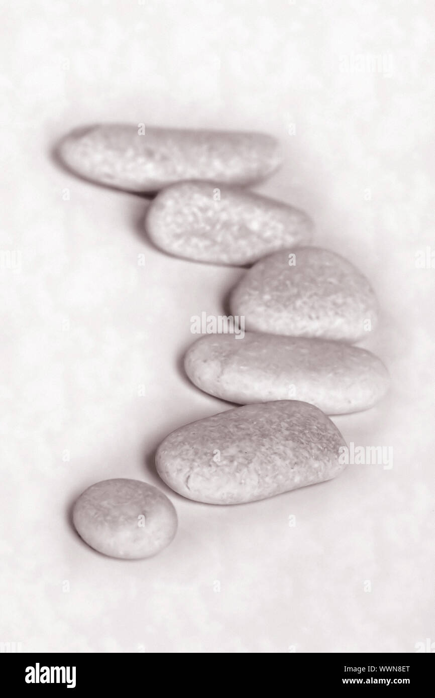 Stepping white stones with dark background Stock Photo - Alamy