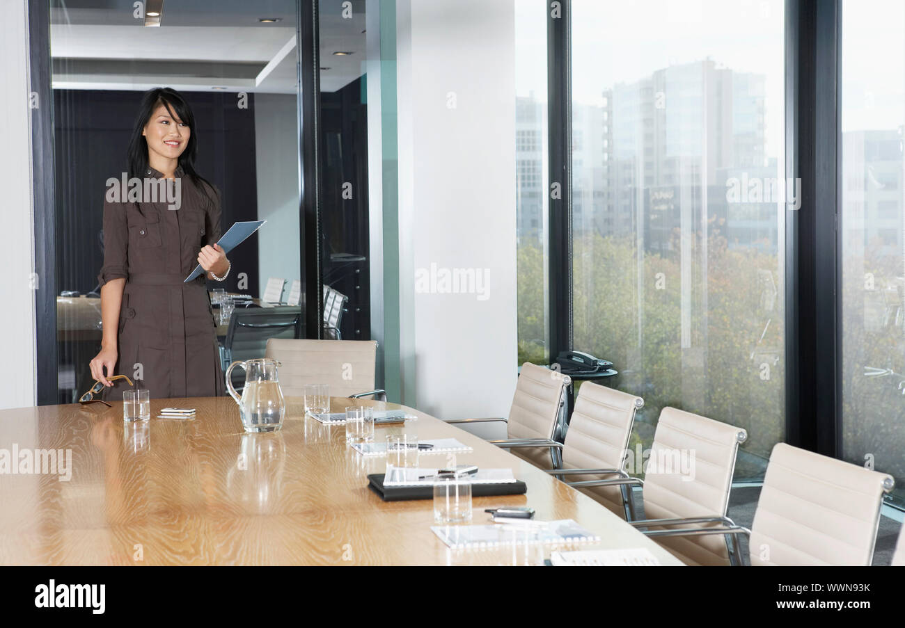 Businesswoman Standing in Conference Room Stock Photo - Alamy