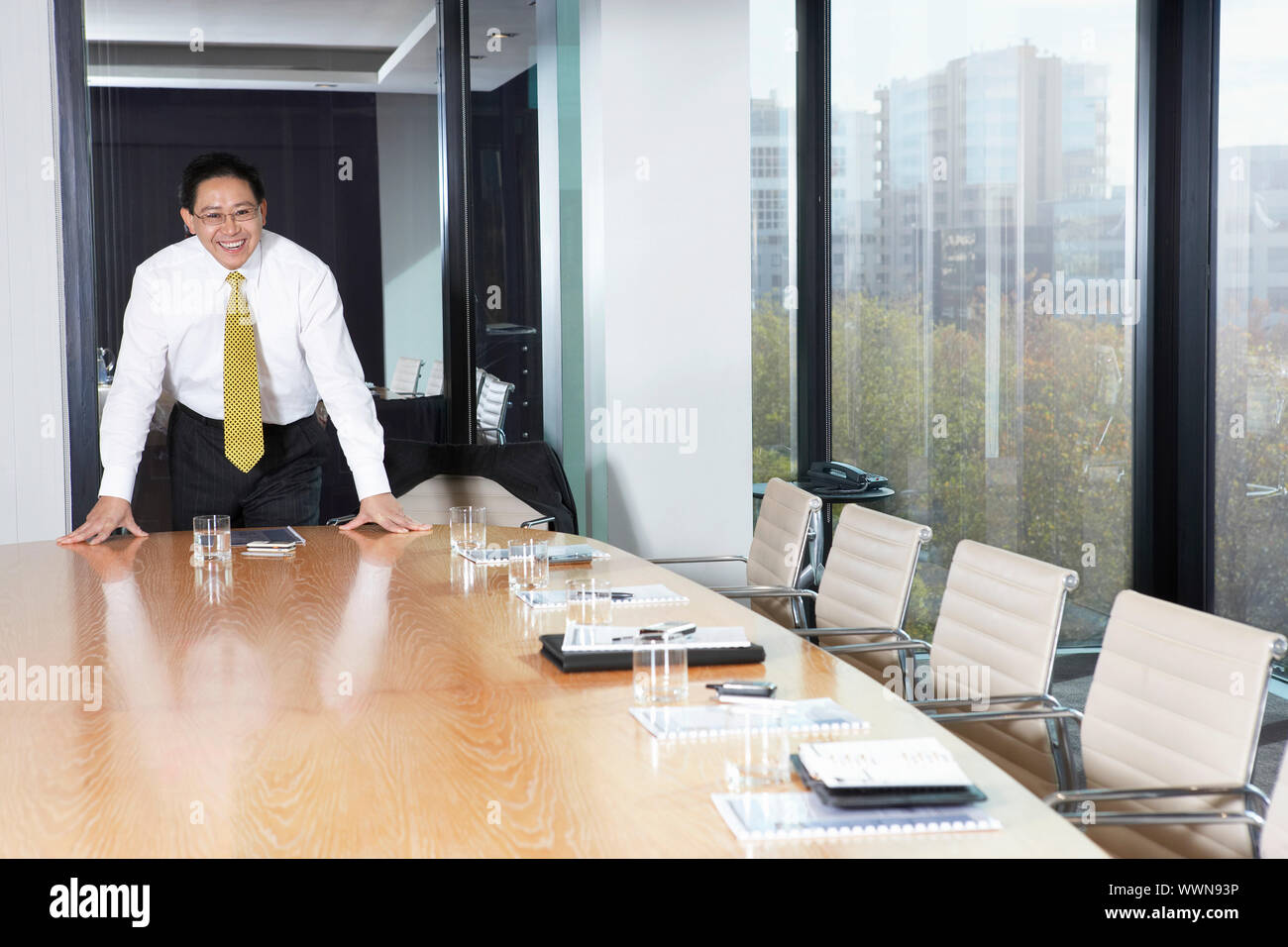 Businessman Standing in Conference Room Stock Photo - Alamy