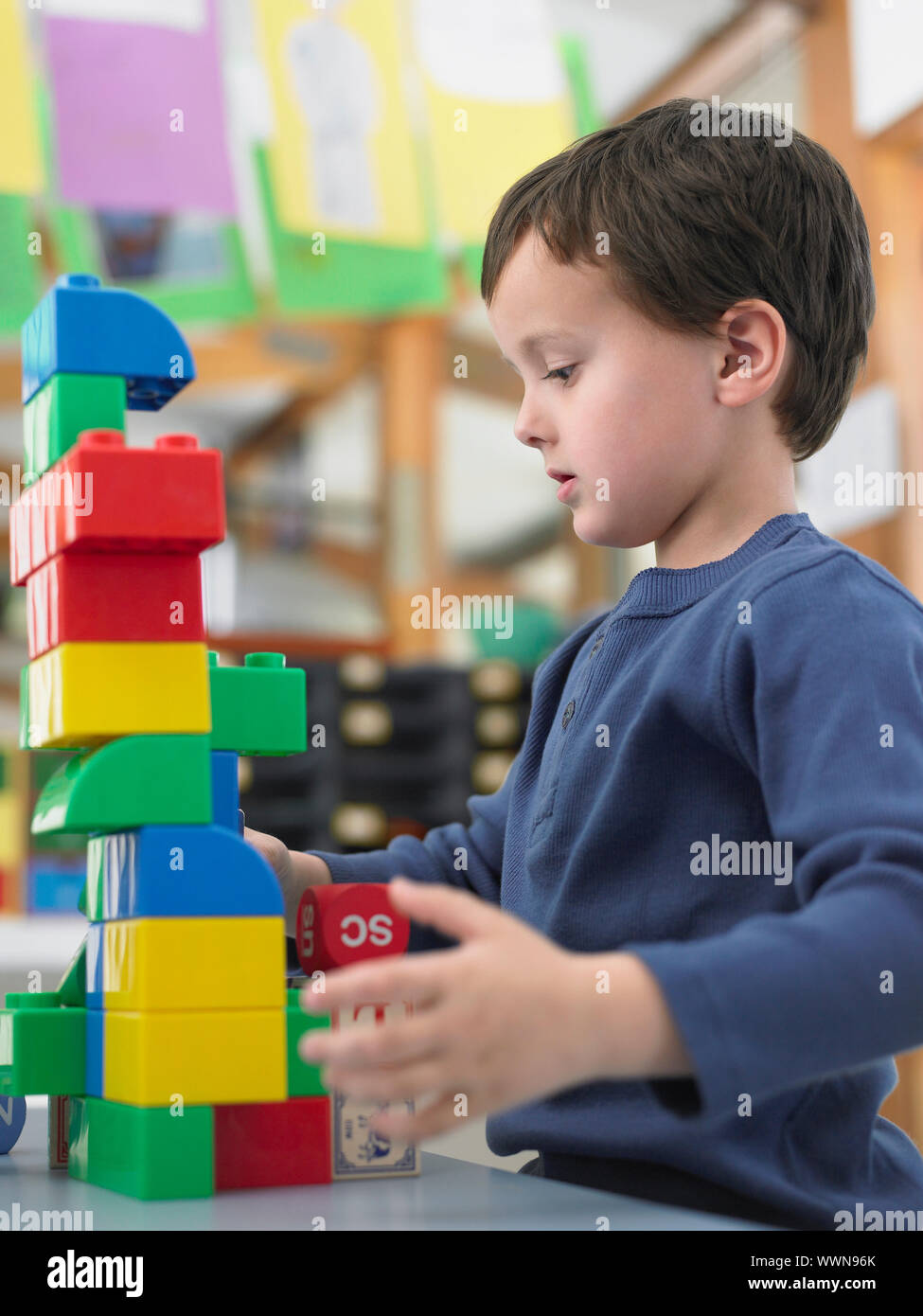 Elementary Student Playing With Building Blocks Stock Photo - Alamy