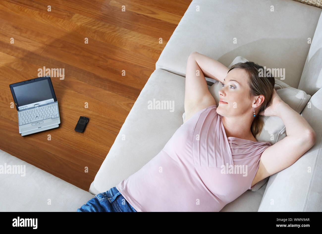 Woman Relaxing on Couch Stock Photo - Alamy