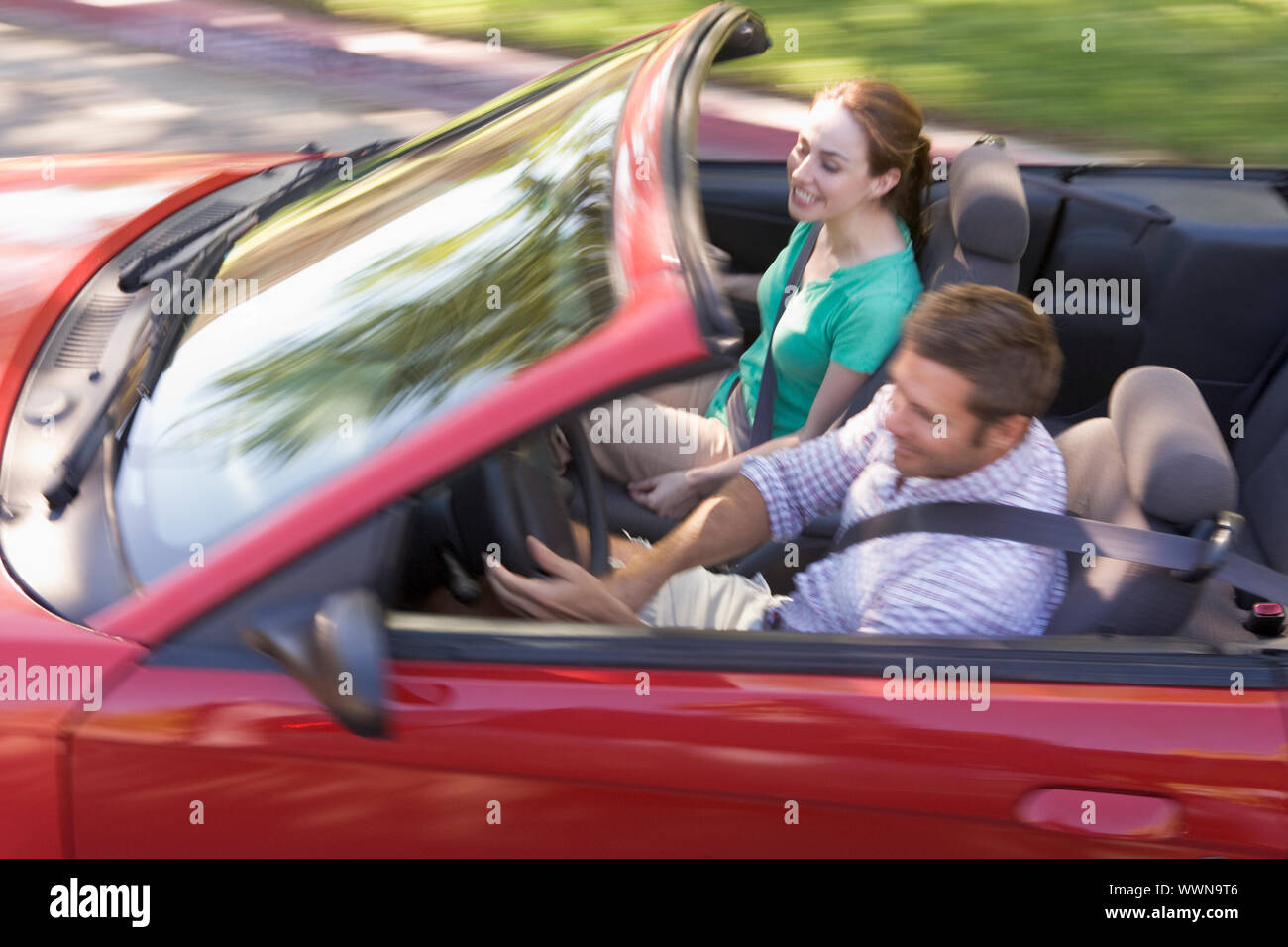Couple in convertible car smiling Stock Photo - Alamy