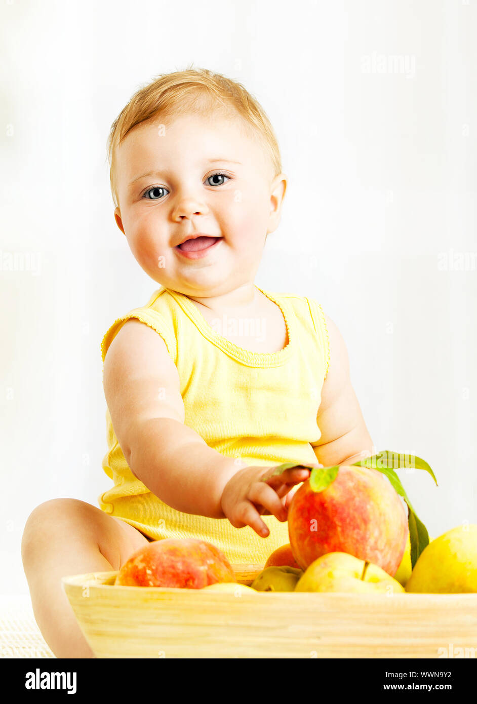 Little baby choosing fruits Stock Photo - Alamy