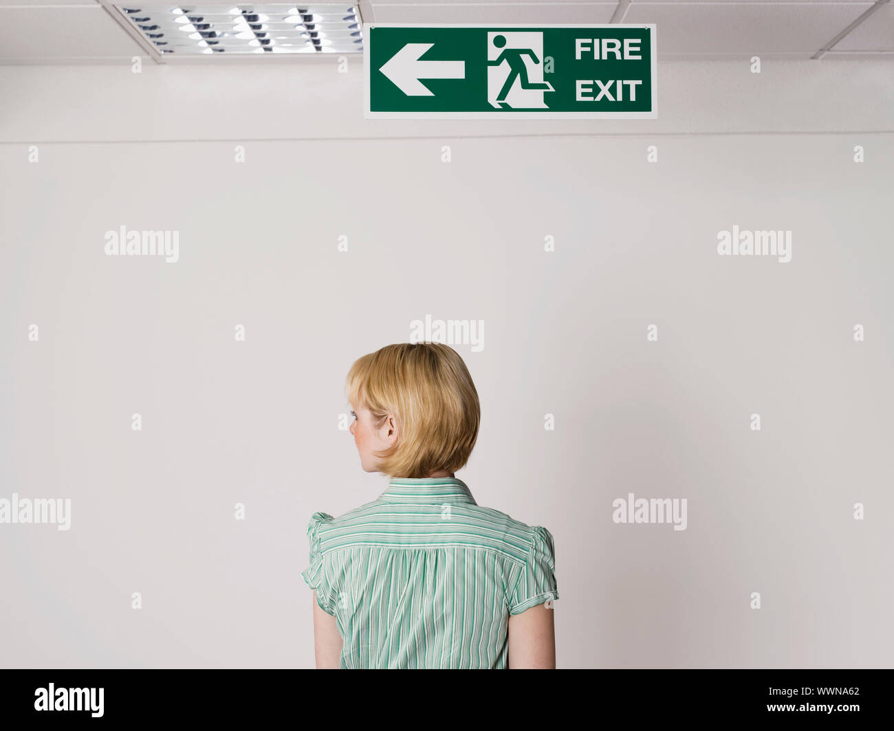 Standing under exit sign hi-res stock photography and images - Alamy