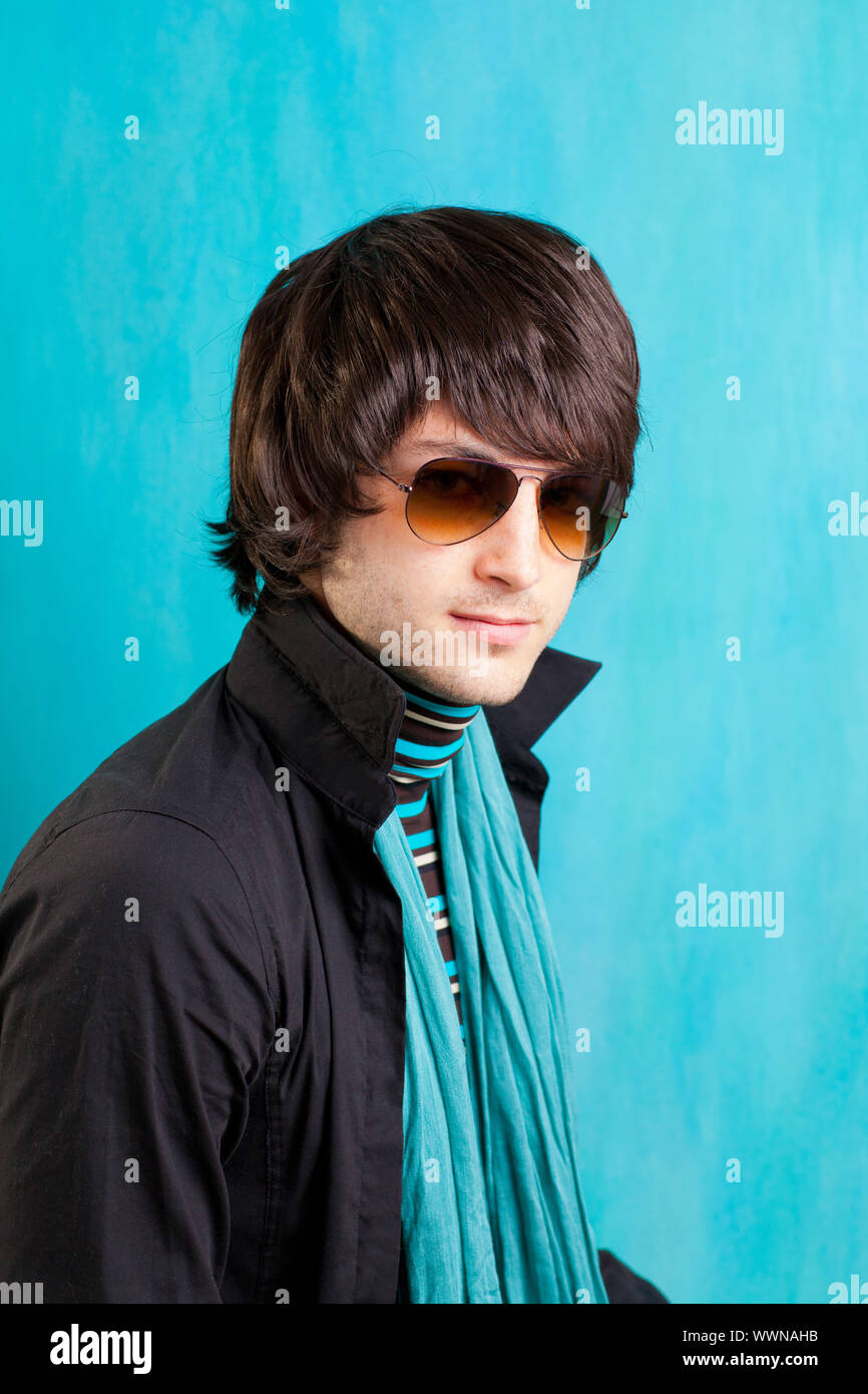 british indie pop rock look retro hip young man with sunglasses on blue ...