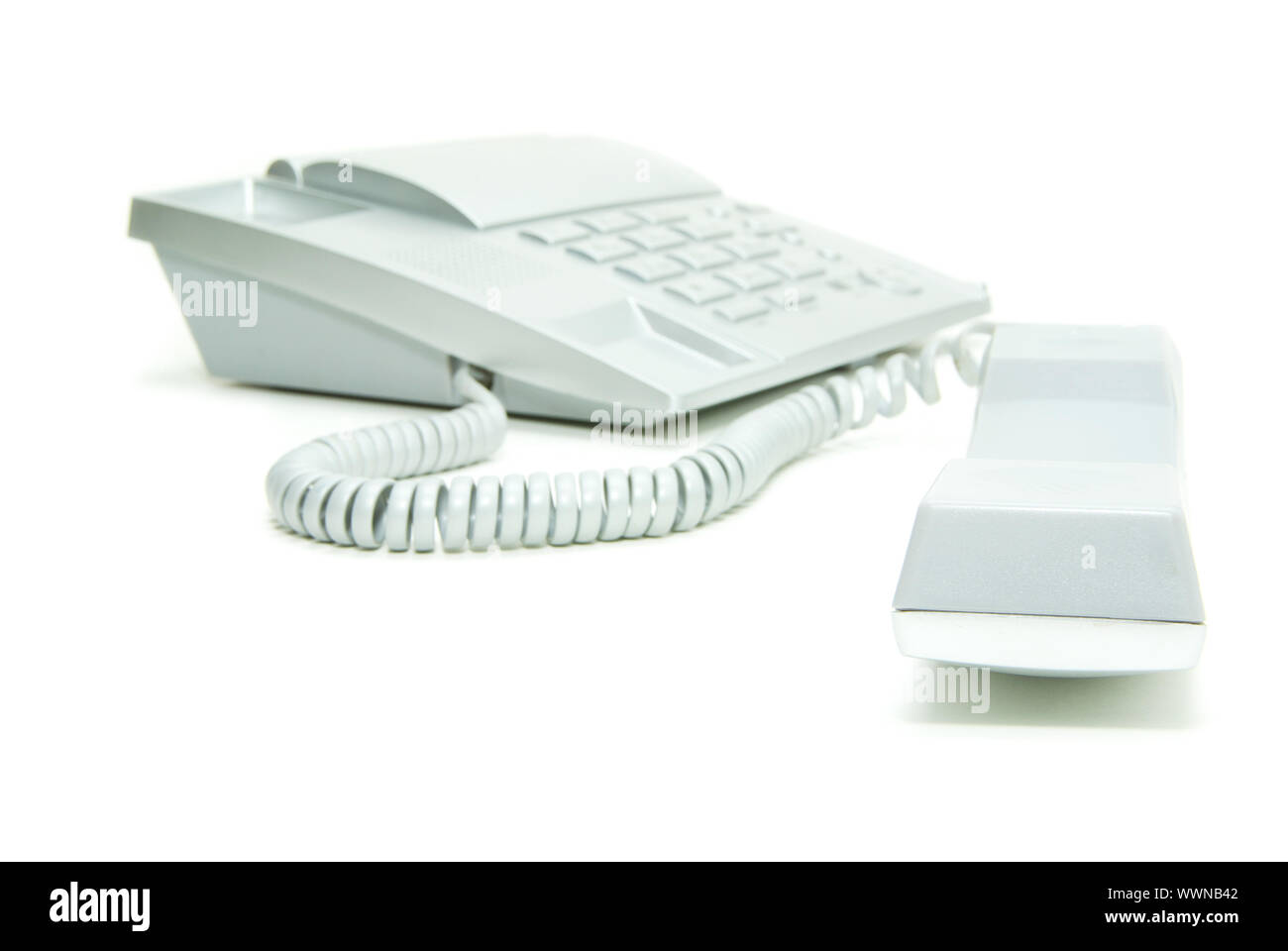 grey office telephone on a white background Stock Photo - Alamy