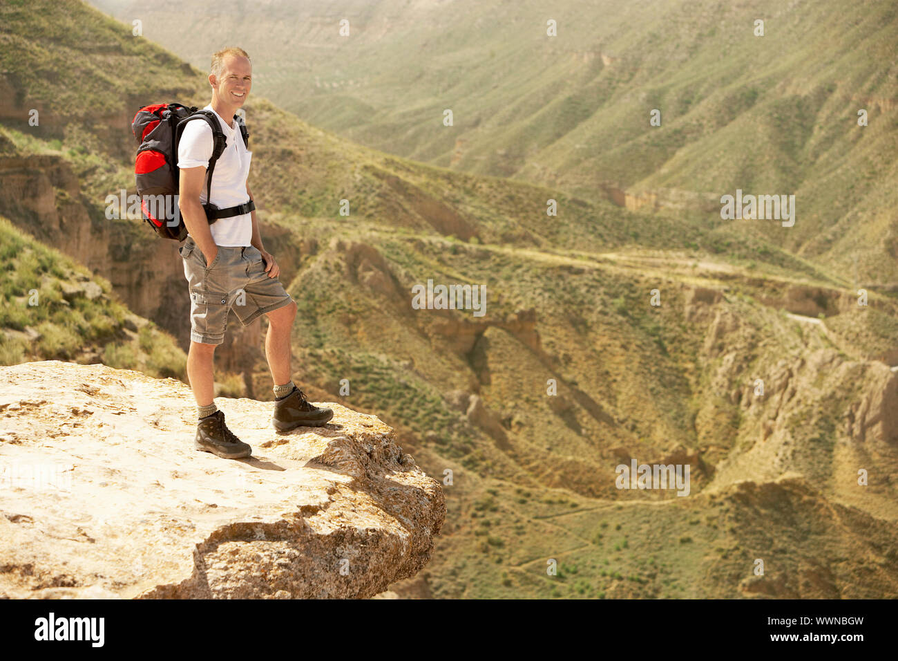 Hiker on Top of Mountain Range Stock Photo - Alamy