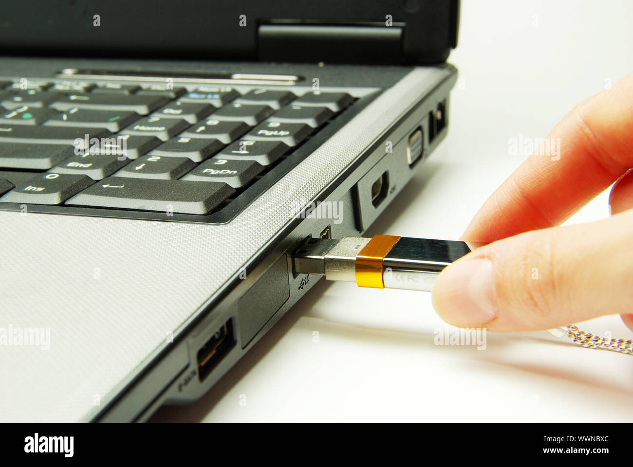 Notebook with a modem usb on white Stock Photo - Alamy