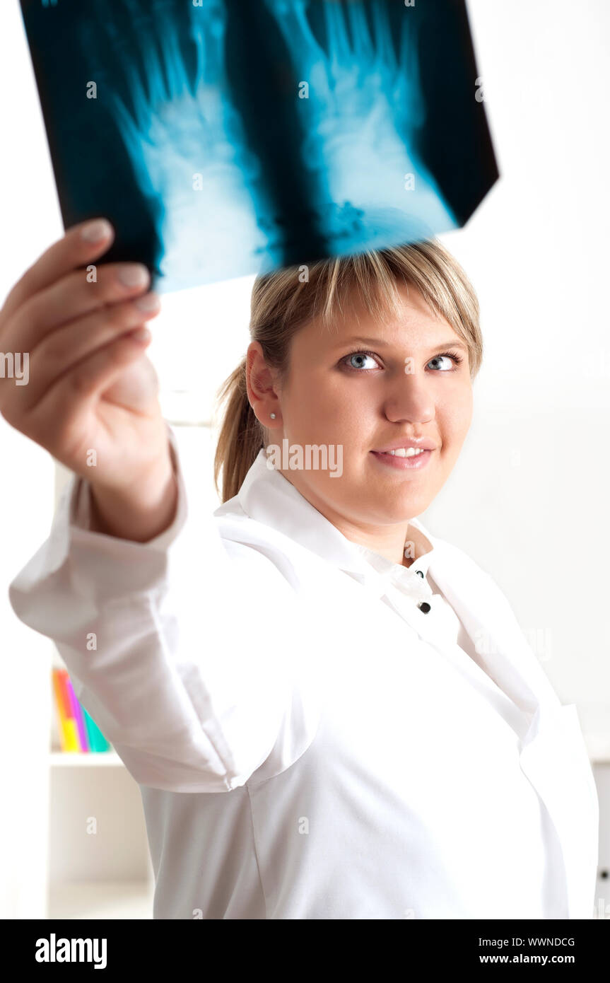 woman doctor looks at x-ray film, smile Stock Photo - Alamy