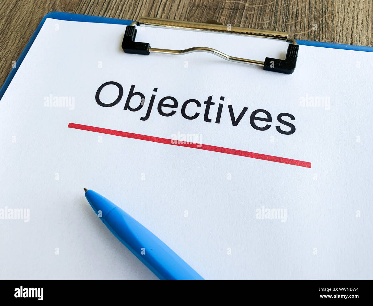 Paper with text objective on wood table Stock Photo - Alamy
