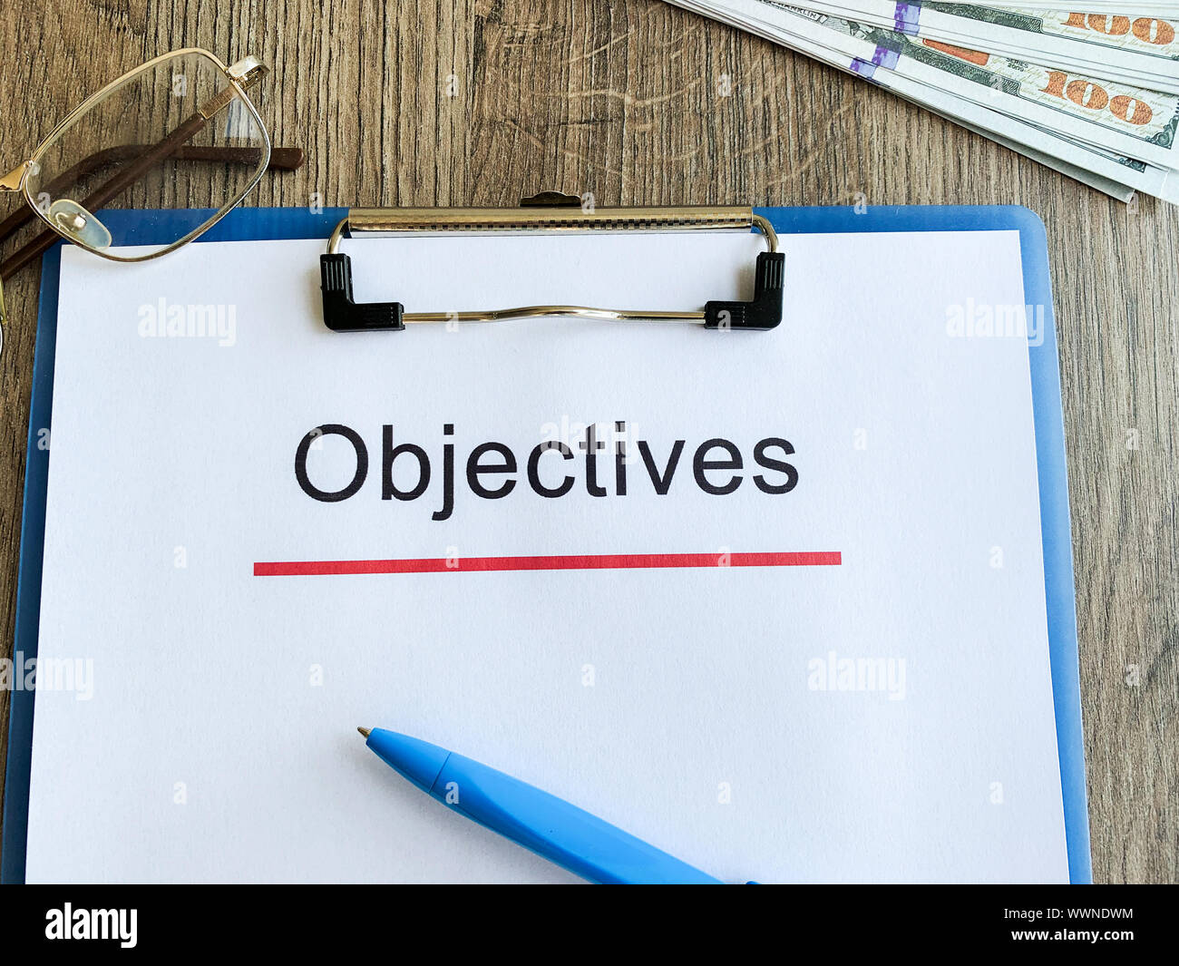 Paper with text objective on wood table Stock Photo - Alamy