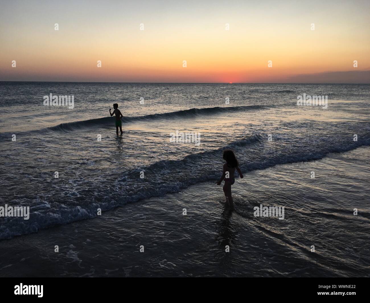 Childrens on sunset beach Stock Photo - Alamy
