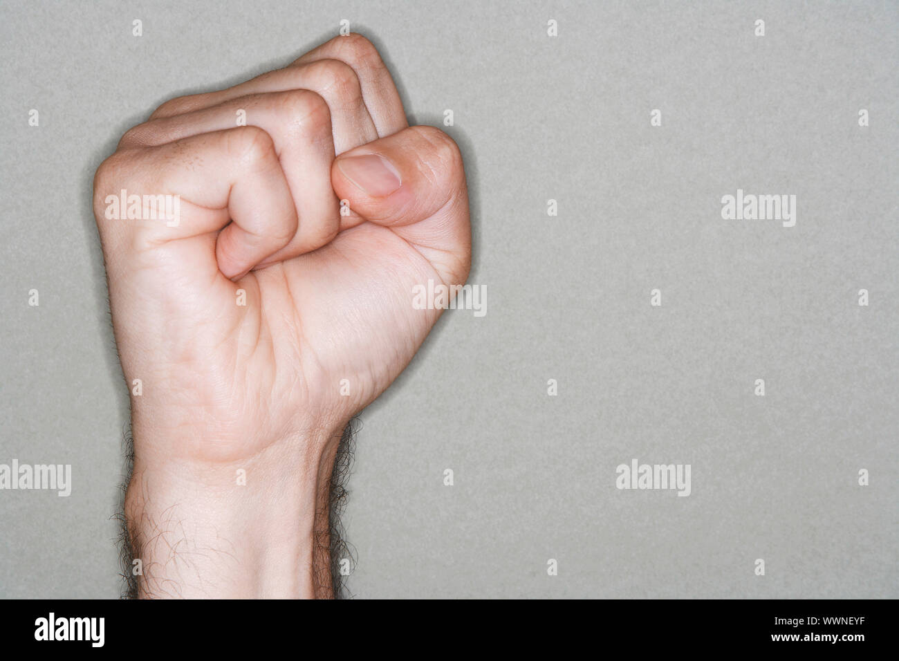 Man's Hand Clenched in Fist Stock Photo - Alamy