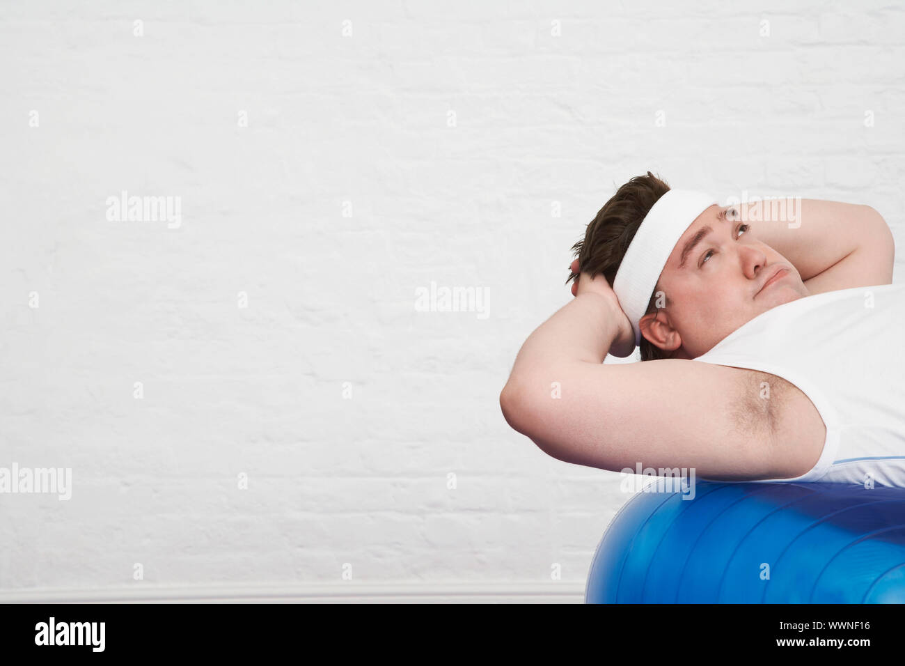 Overweight Man Exercising on Ball Stock Photo - Alamy