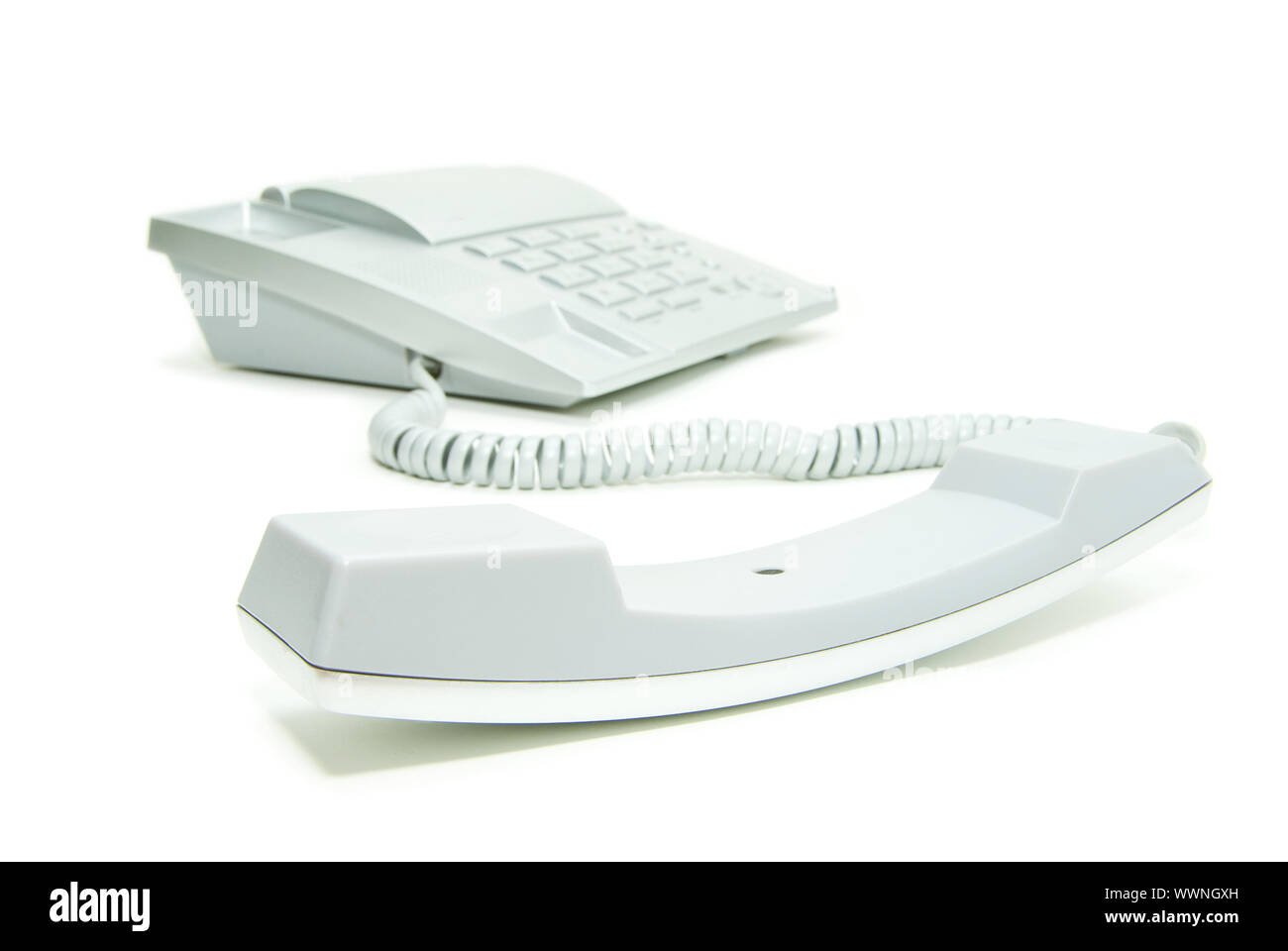grey office telephone on a white background Stock Photo - Alamy