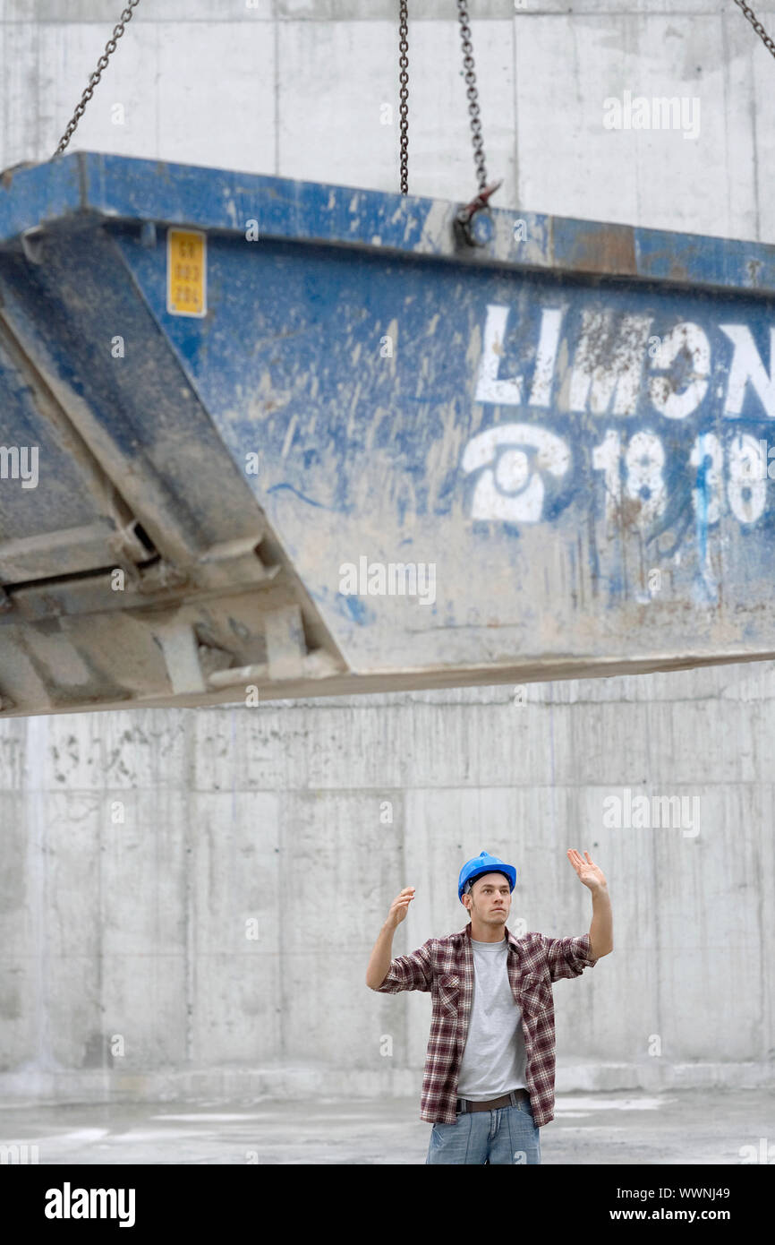 Worker Directing Movement of Container Stock Photo - Alamy