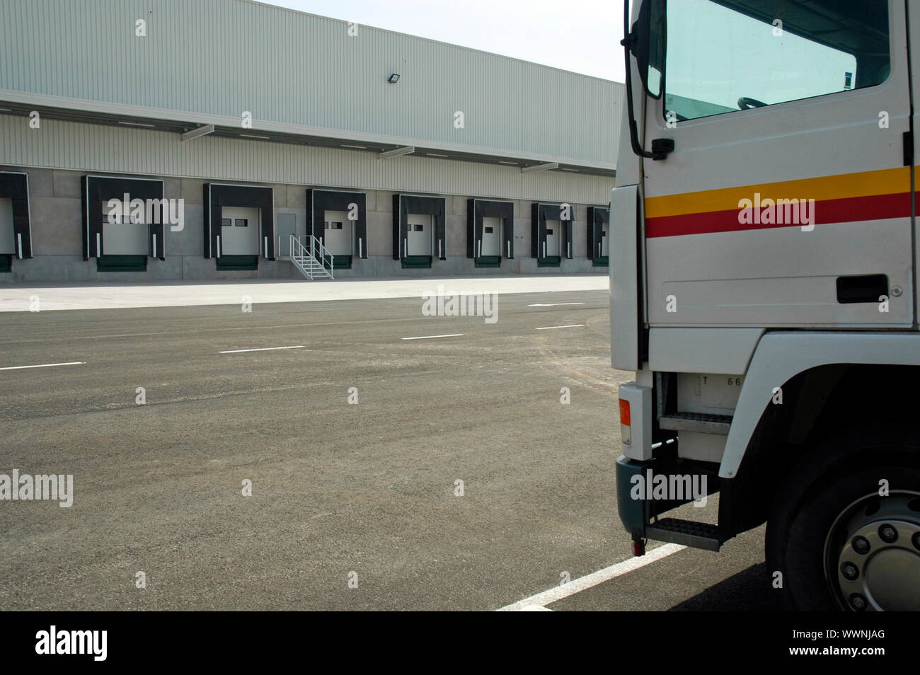 The loading area of a industrial warehouse with several loading bays ...