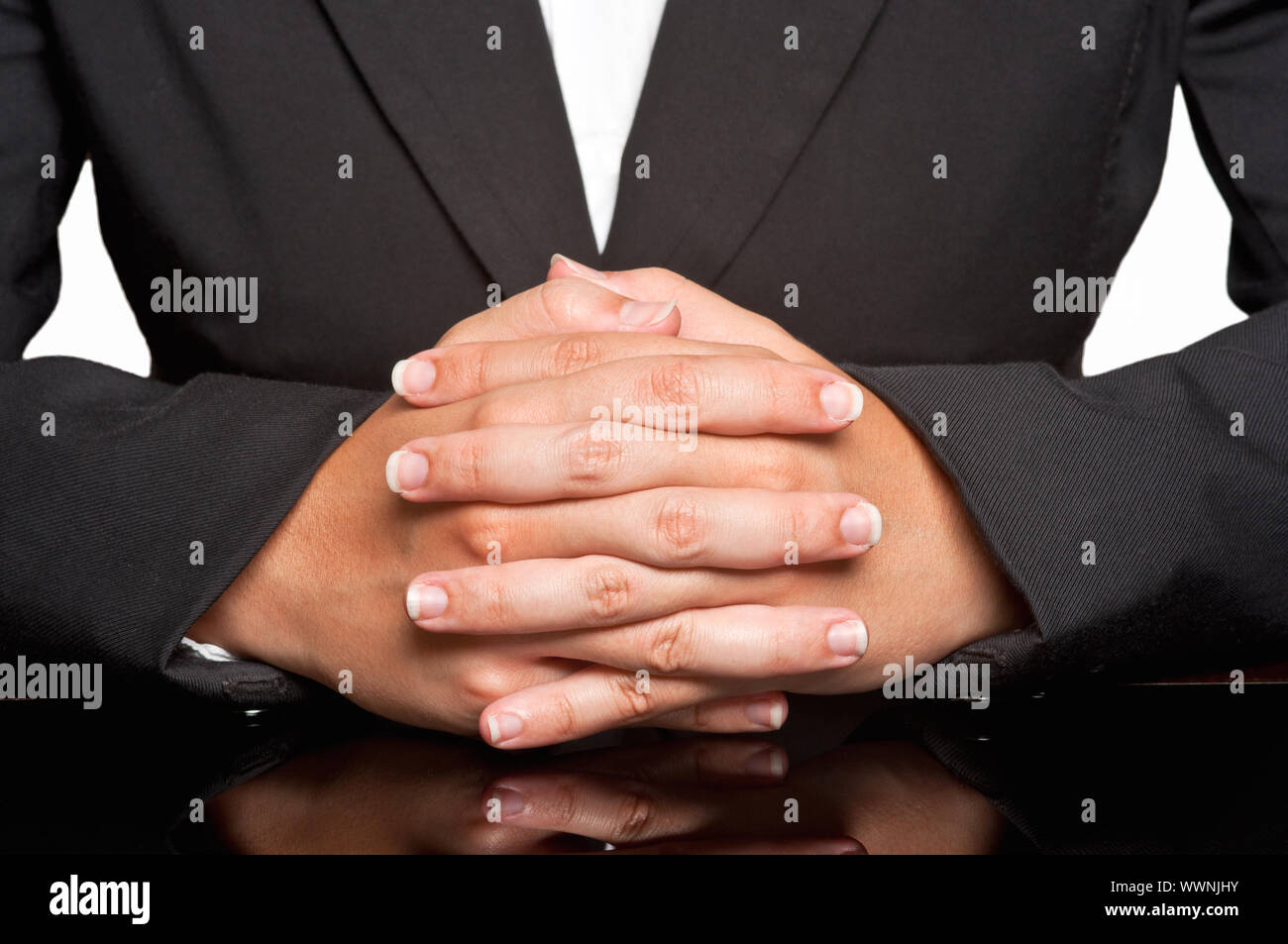 Business woman waiting with fingers crossed Stock Photo - Alamy