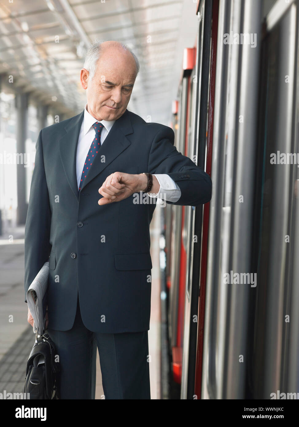 Businessman Waiting at Train Station Stock Photo - Alamy