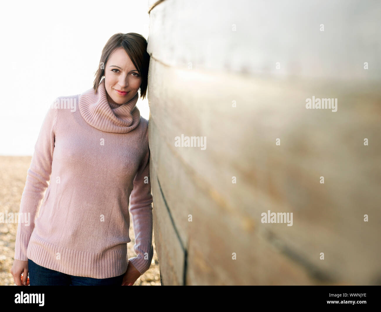 Woman Leaning Against a Boat Stock Photo - Alamy