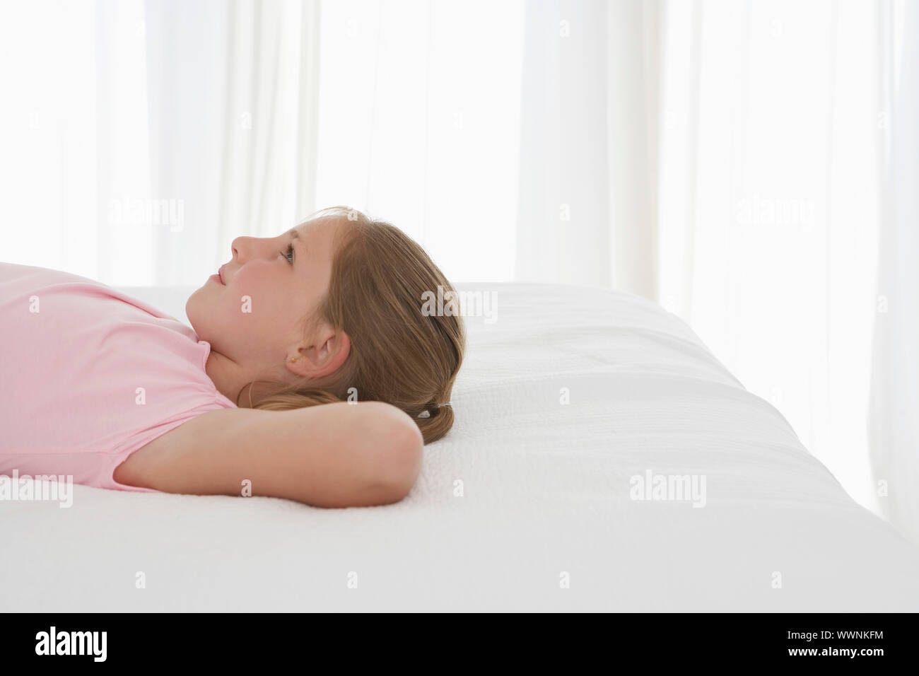 Girl Relaxing on Bed Stock Photo - Alamy