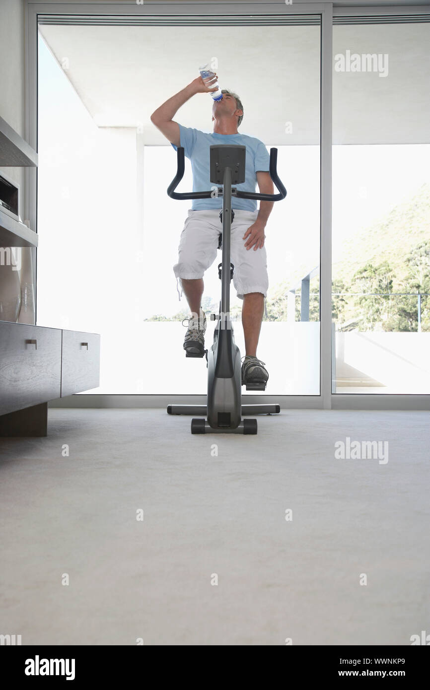 Man on Exercise Bicycle Stock Photo - Alamy