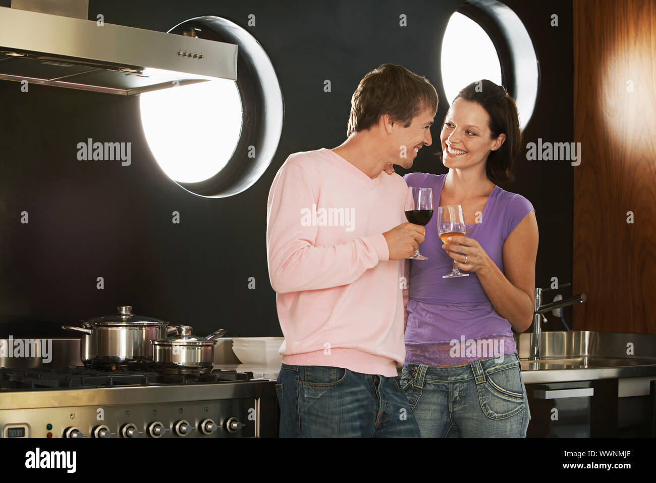 Romantic Couple Drinking Wine in Kitchen Stock Photo - Alamy