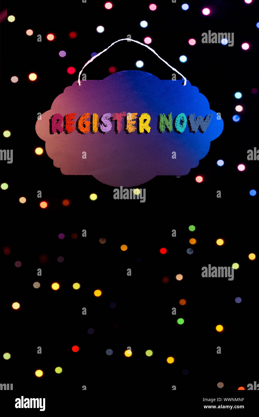 Hand holding sign board with Register now wording on it Stock Photo - Alamy