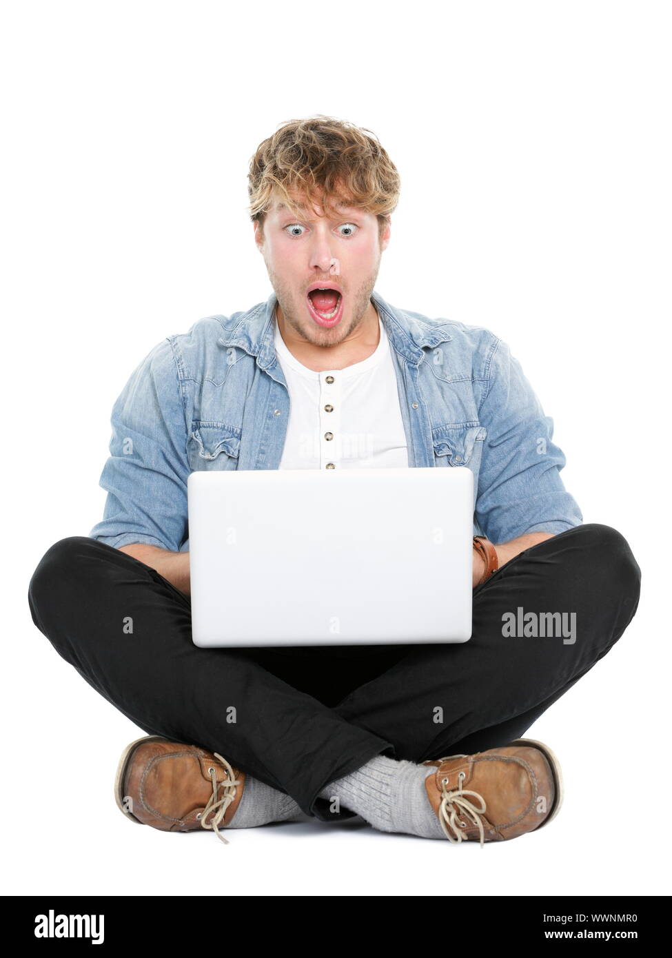 Laptop computer man shocked looking surprised at screen. Young modern ...