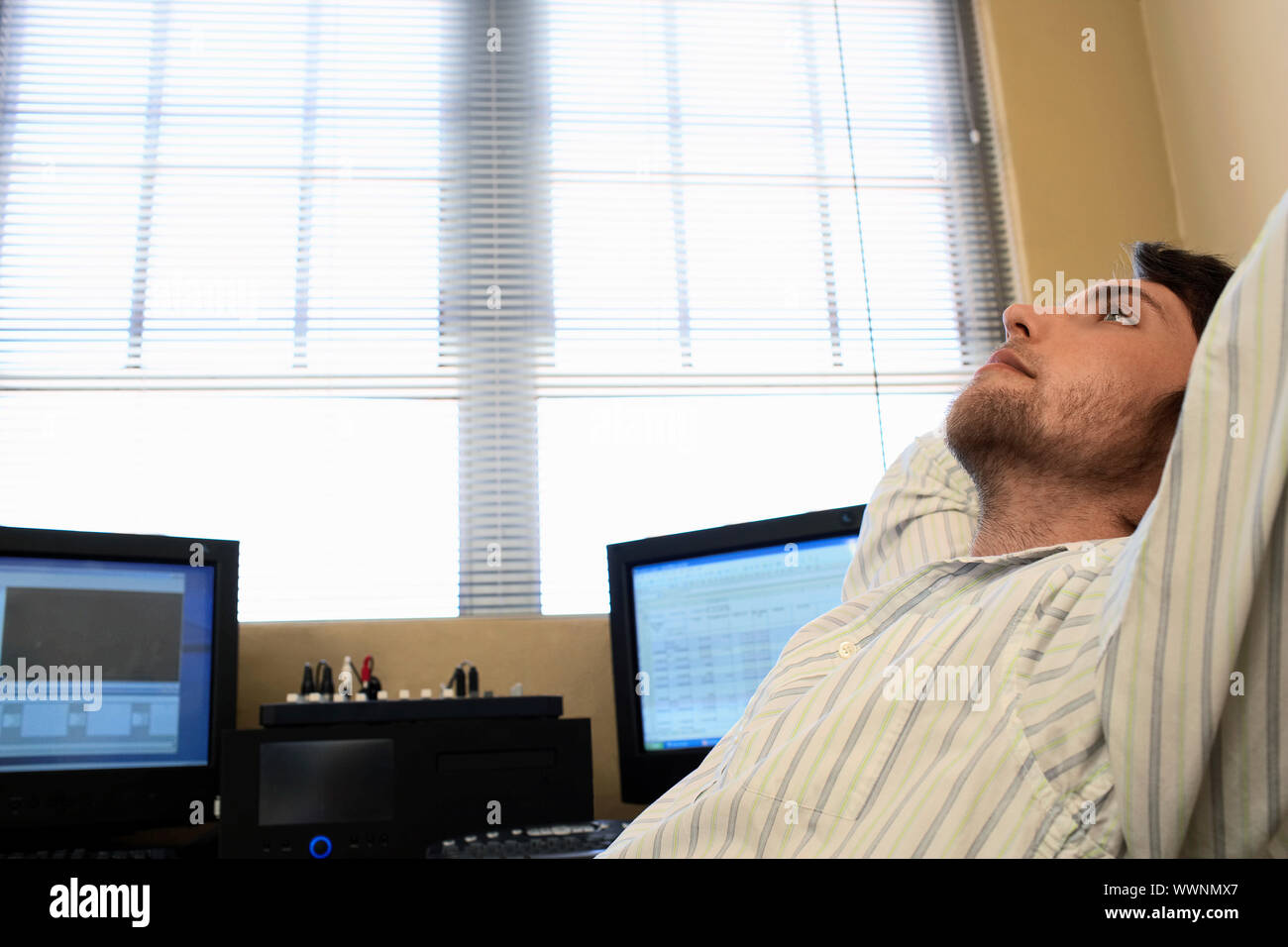 Man Relaxing by Computer Stock Photo - Alamy