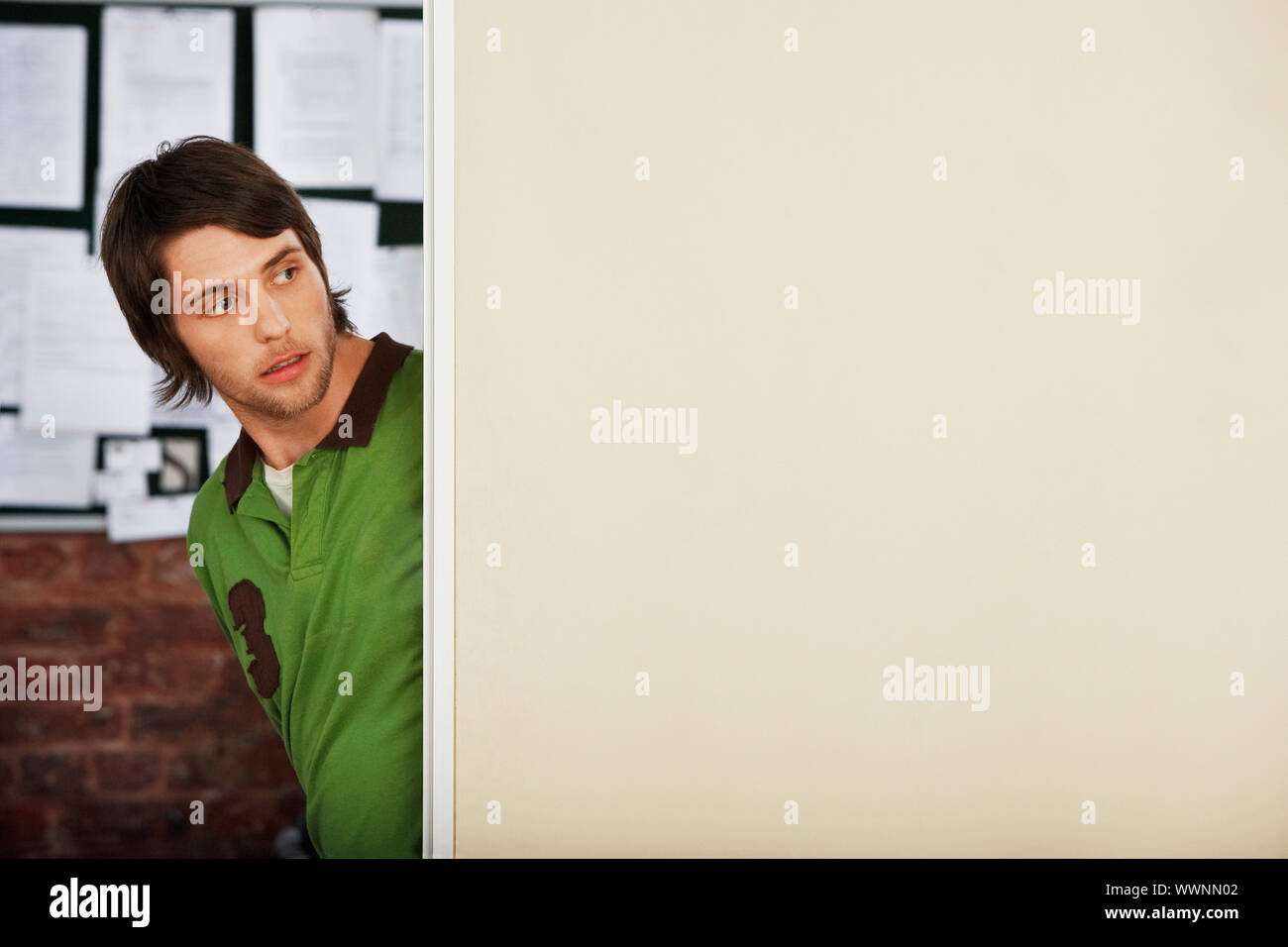 Man Looking Around Corner Stock Photo - Alamy