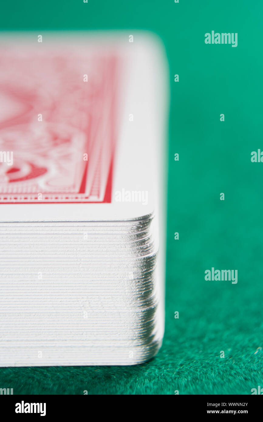 Deck of cards on a poker table Stock Photo - Alamy