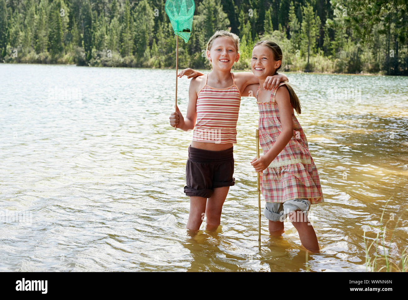 Girls Playing in Lake Stock Photo - Alamy