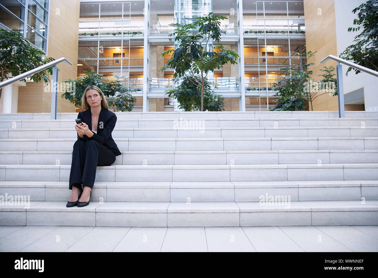 Businesswoman Thinking on Stairs Stock Photo - Alamy