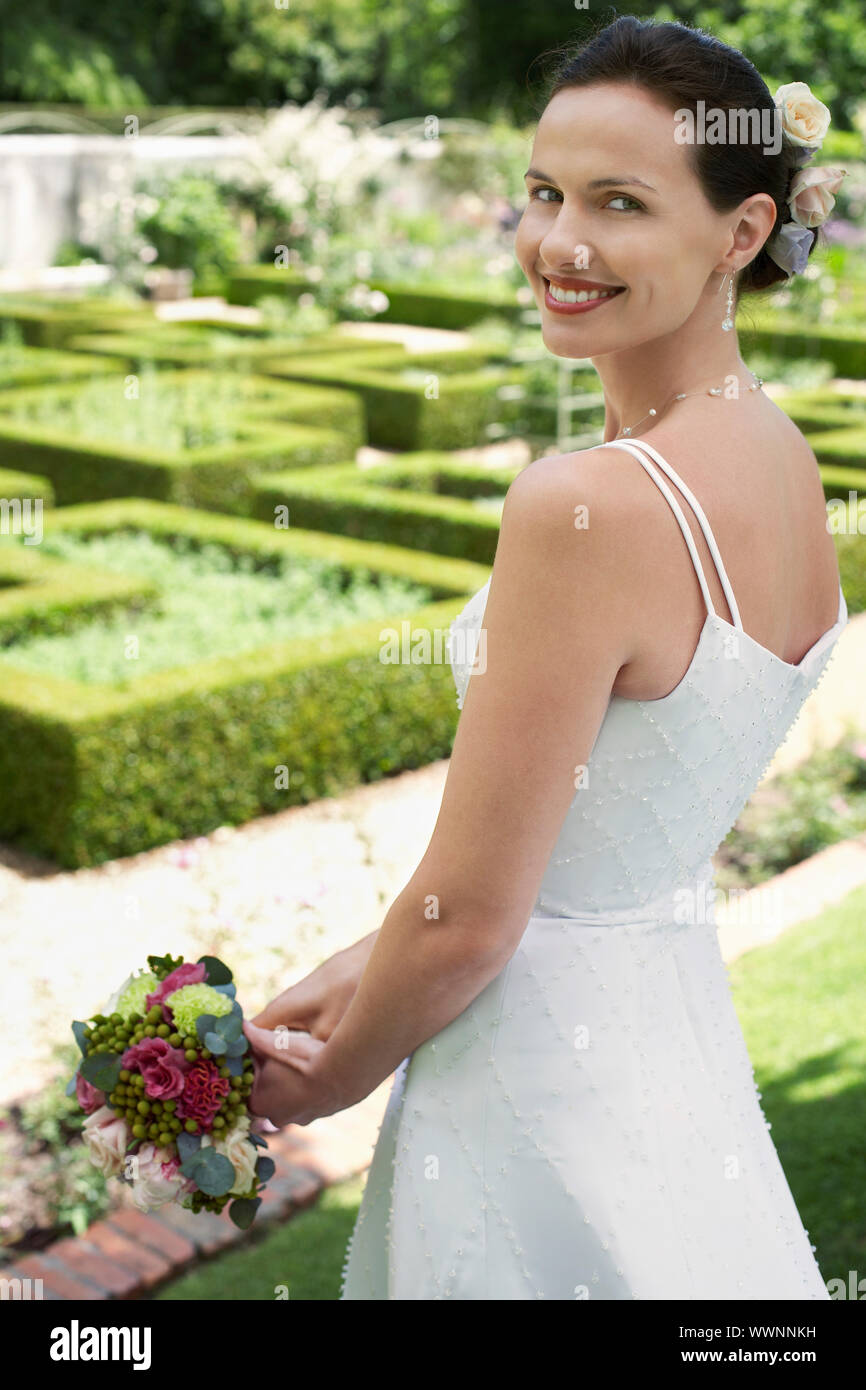 Bride in Formal Garden Stock Photo - Alamy