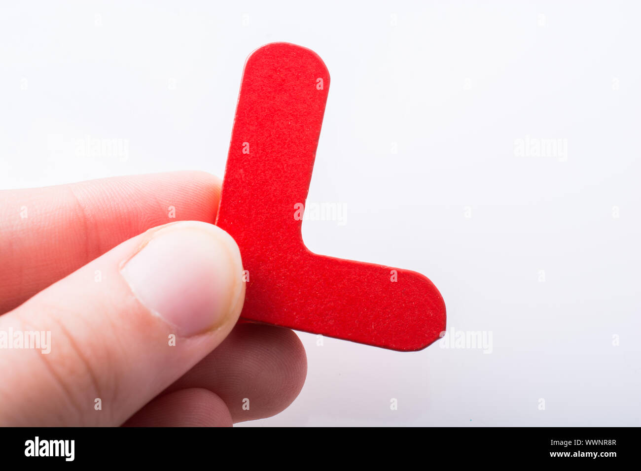 Hand holding letter cube L of made of wood Stock Photo - Alamy