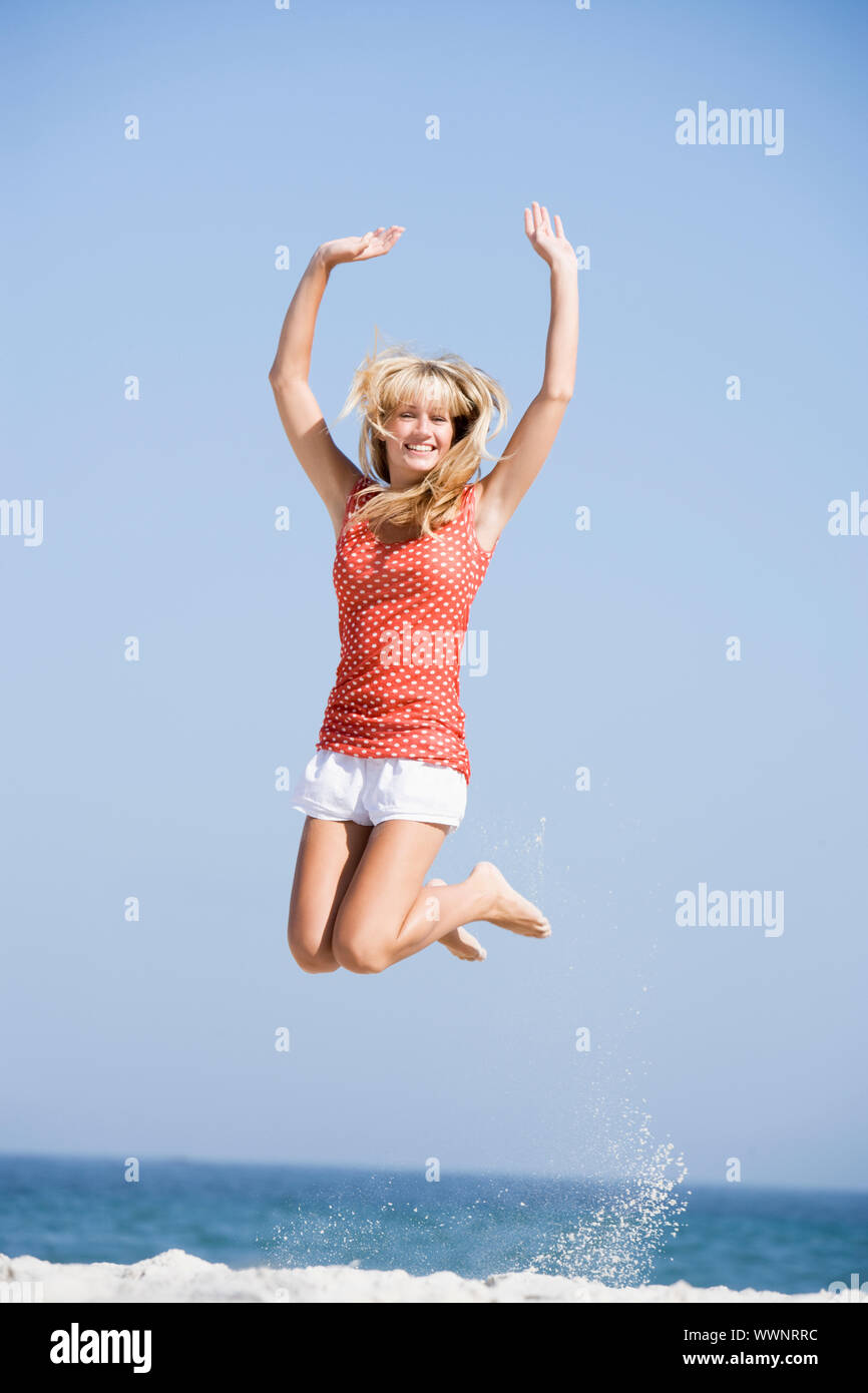 Woman jumping on beach Stock Photo - Alamy