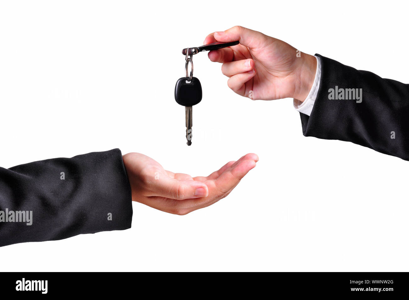 A hand giving a key to another hand. Both persons in suits. Isolated ...