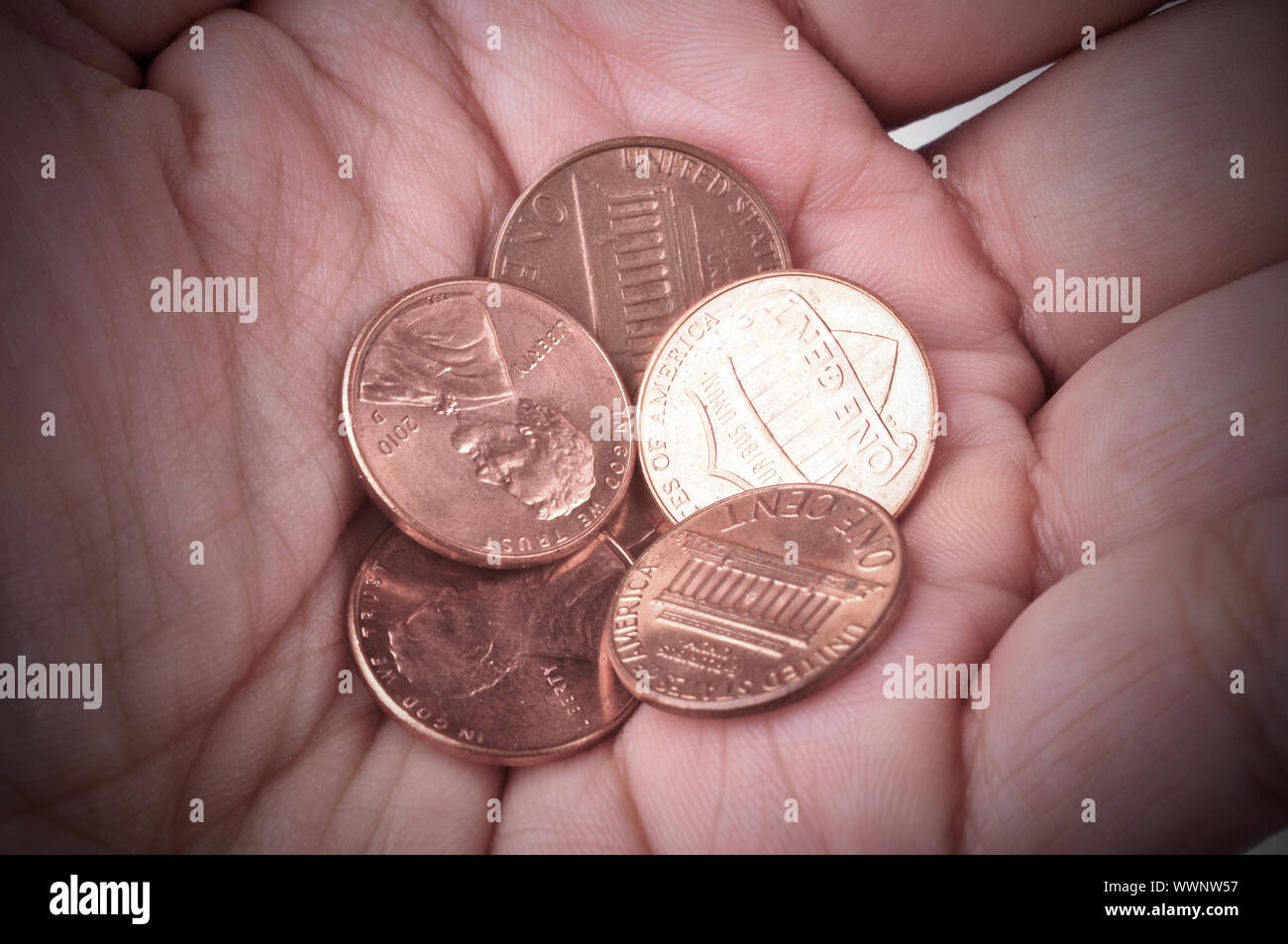 Hand holds some coins. Concept of poverty Stock Photo - Alamy