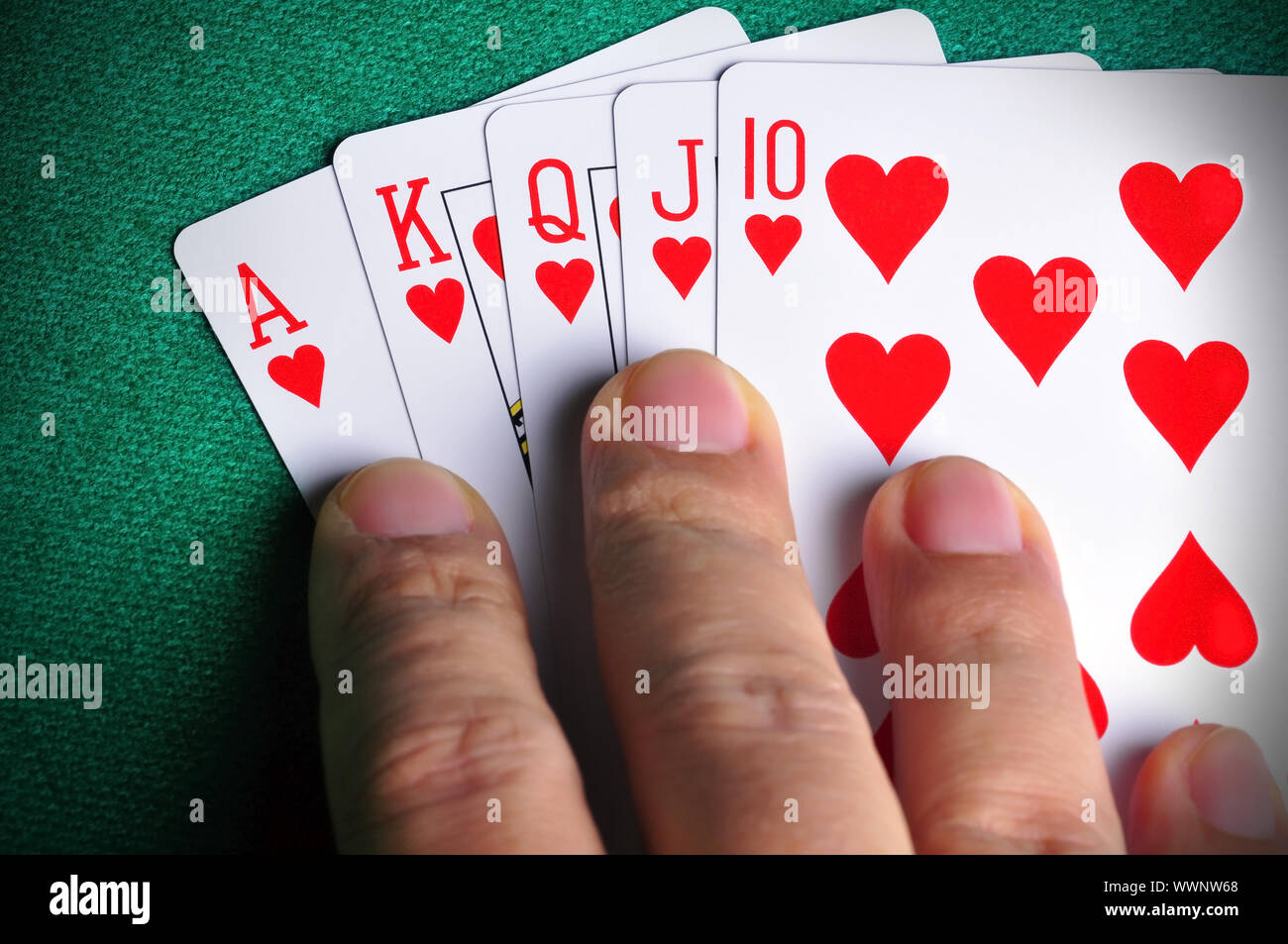Hand holding a Royal Flush poker card sequence Stock Photo - Alamy