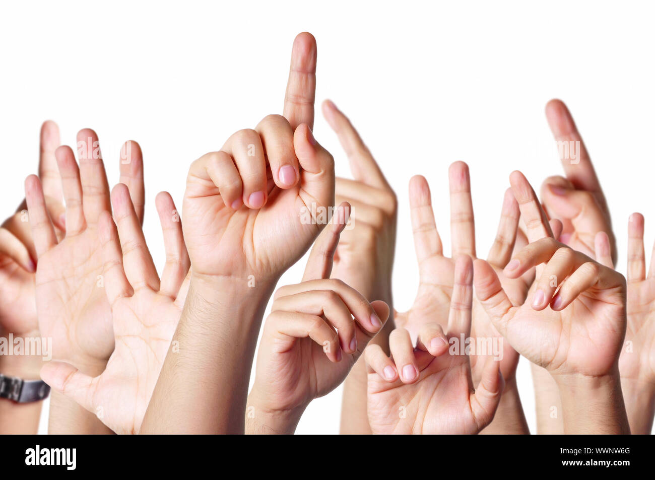 Group of people raising hands to answer a question Stock Photo - Alamy
