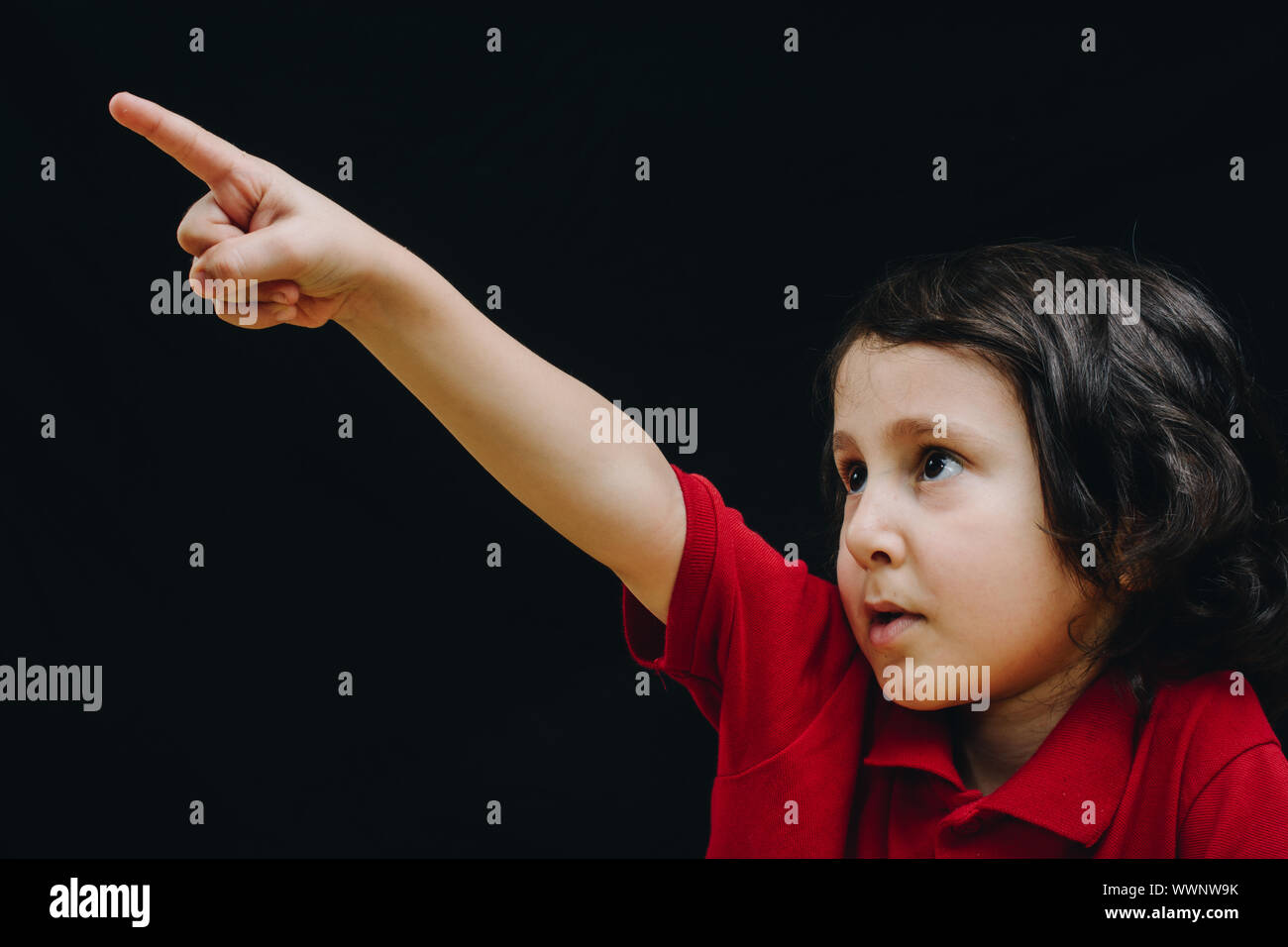 Happy smiling kid boy pointing his finger away Stock Photo - Alamy