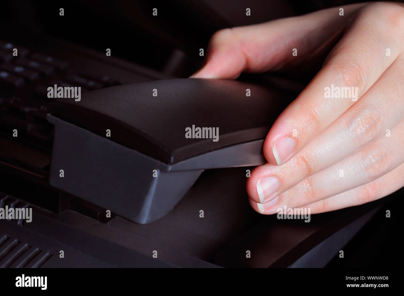Hand picking up a phone to answer it Stock Photo - Alamy