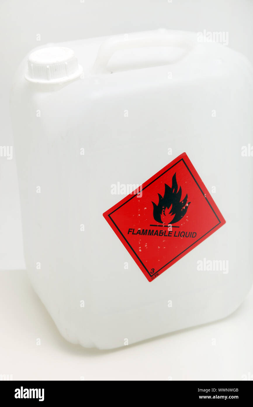 White plastic container with a red flammable hazard label on the ...