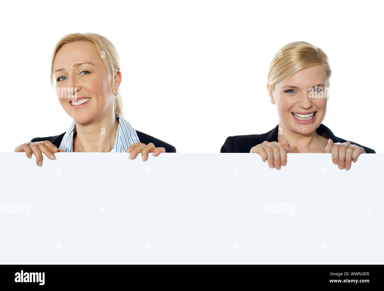 Smiling corporate women showing blank banner ad to camera Stock Photo ...