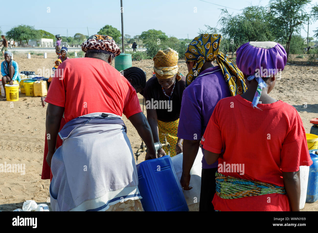 Unidentified Namibian woman with child near public tank with drinking ...