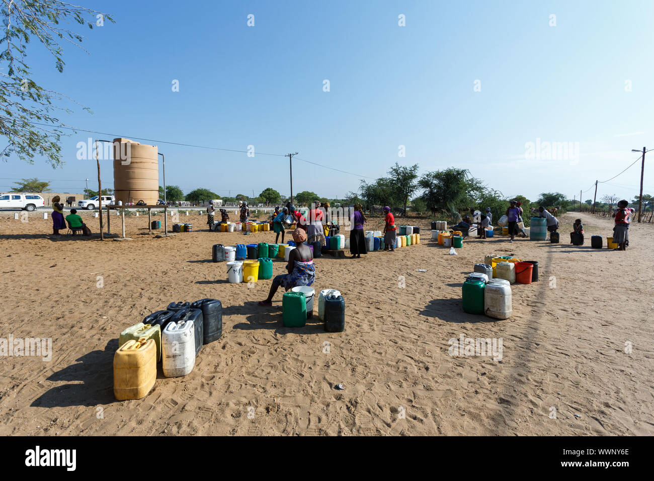 Unidentified Namibian woman with child near public tank with drinking ...