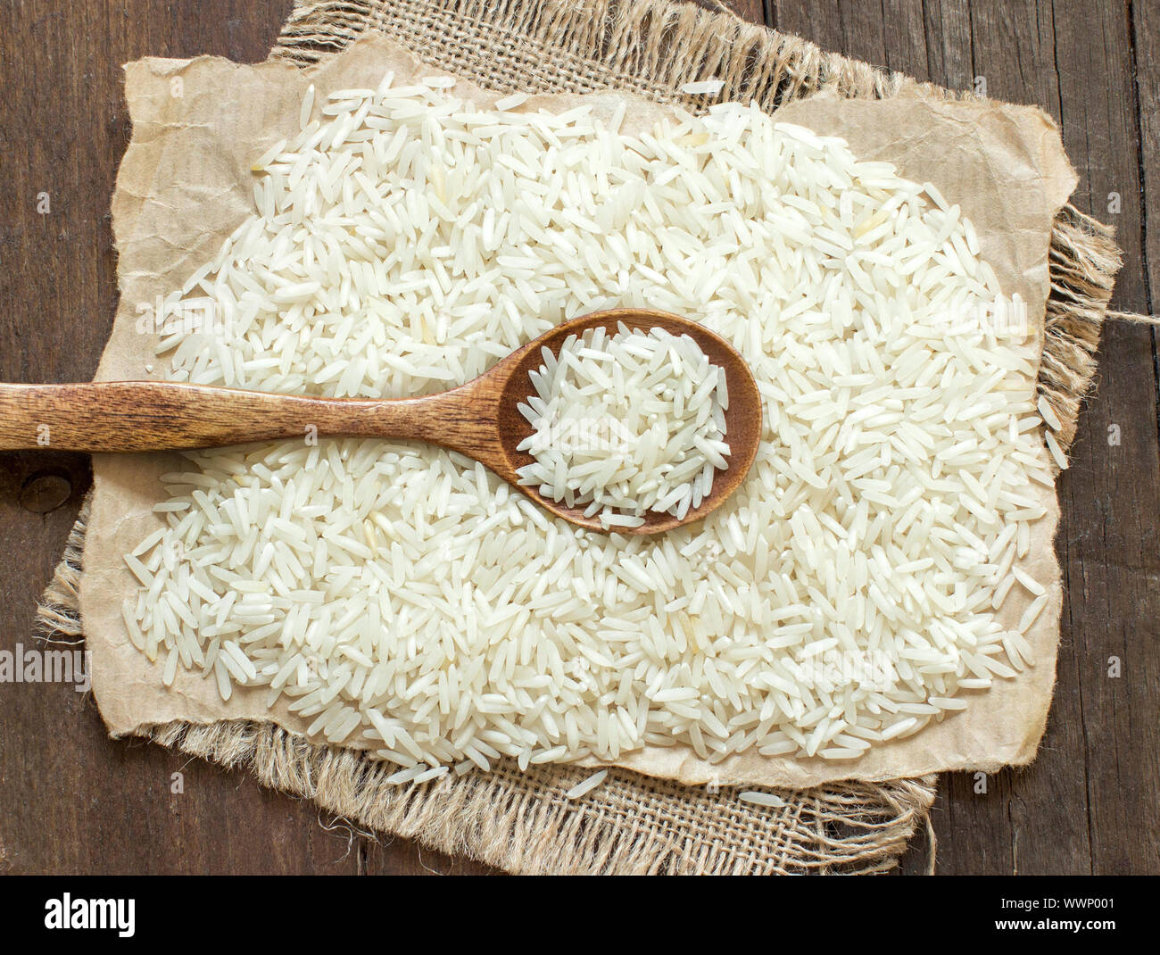 Basmati rice with a spoon on an dark wood Stock Photo - Alamy