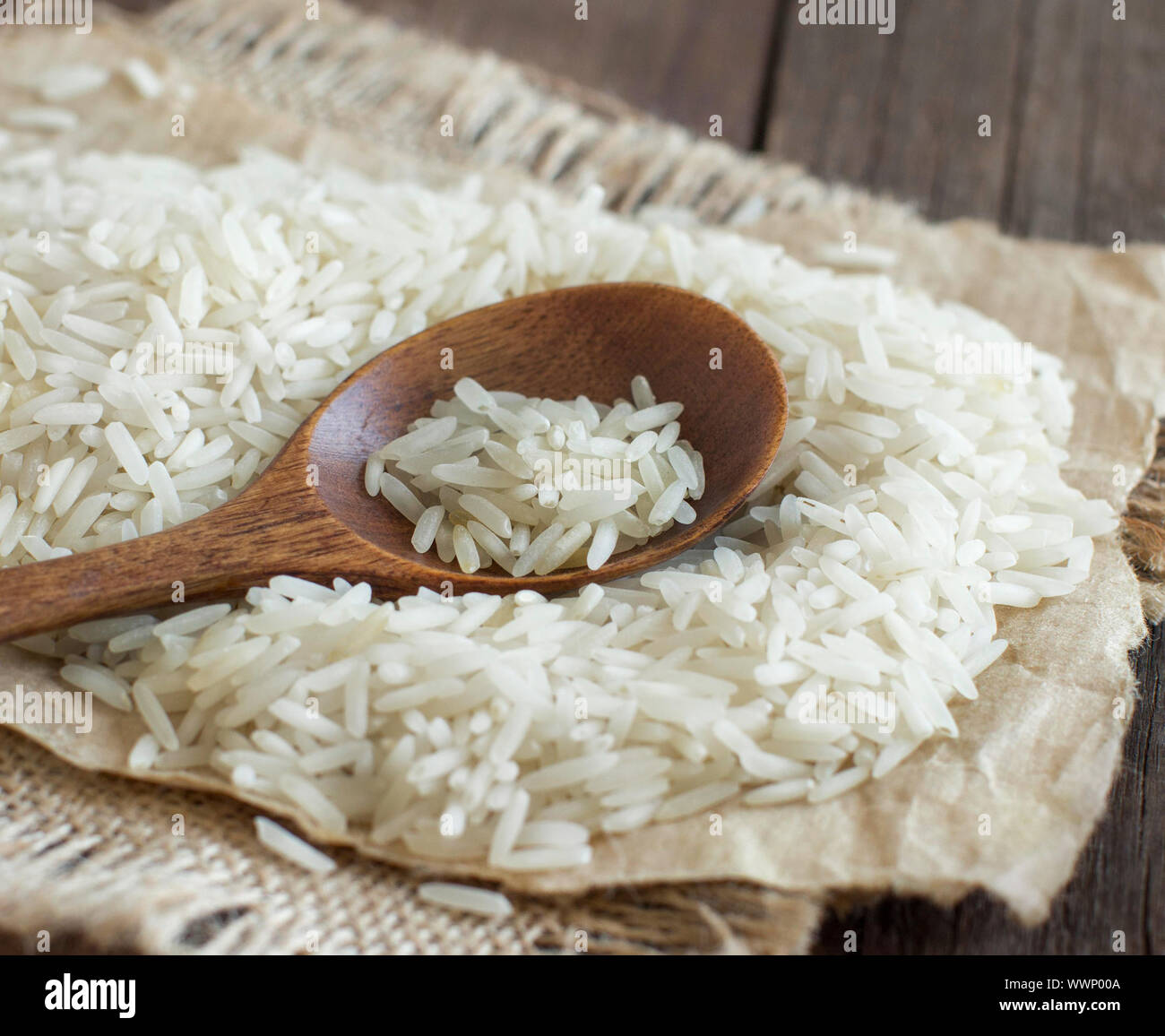 Basmati rice with a spoon on an dark wood Stock Photo - Alamy