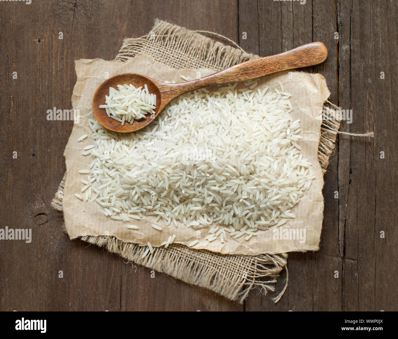 Basmati rice with a spoon on an dark wood Stock Photo - Alamy